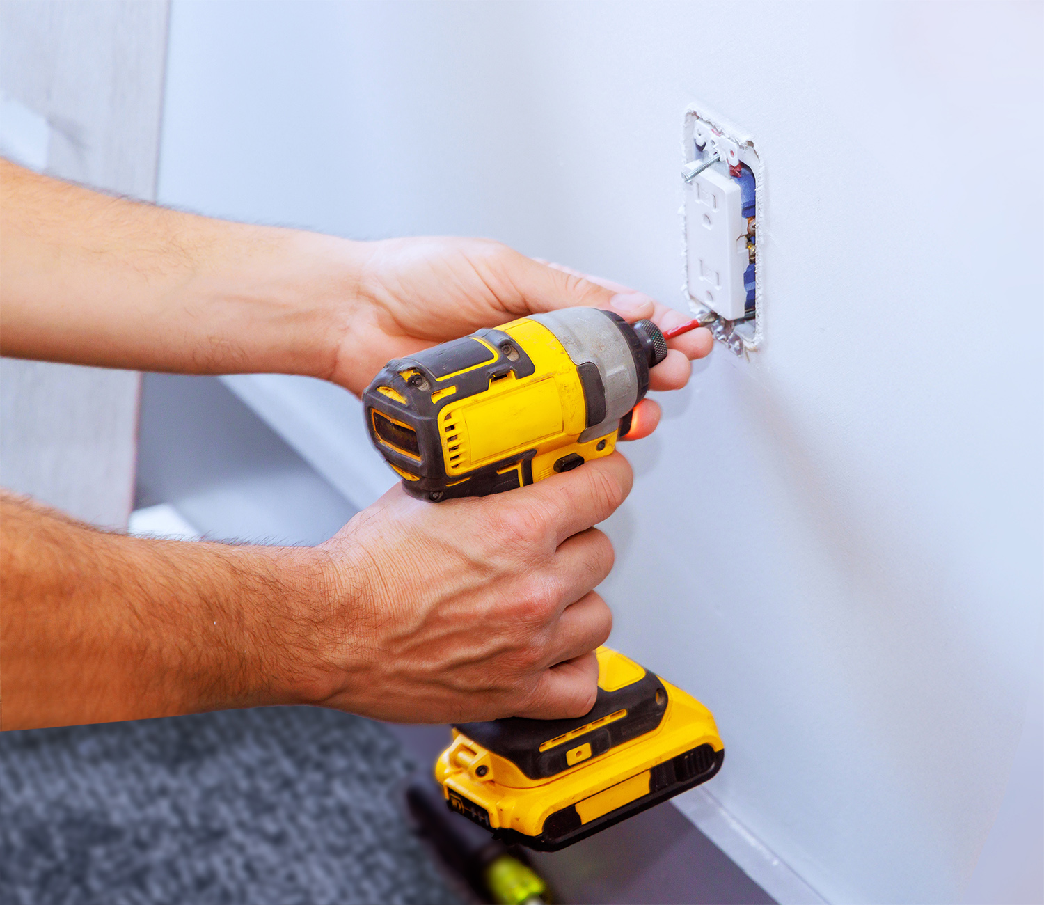 Installing an outlet with screwdriver in a house during reconstruction ...